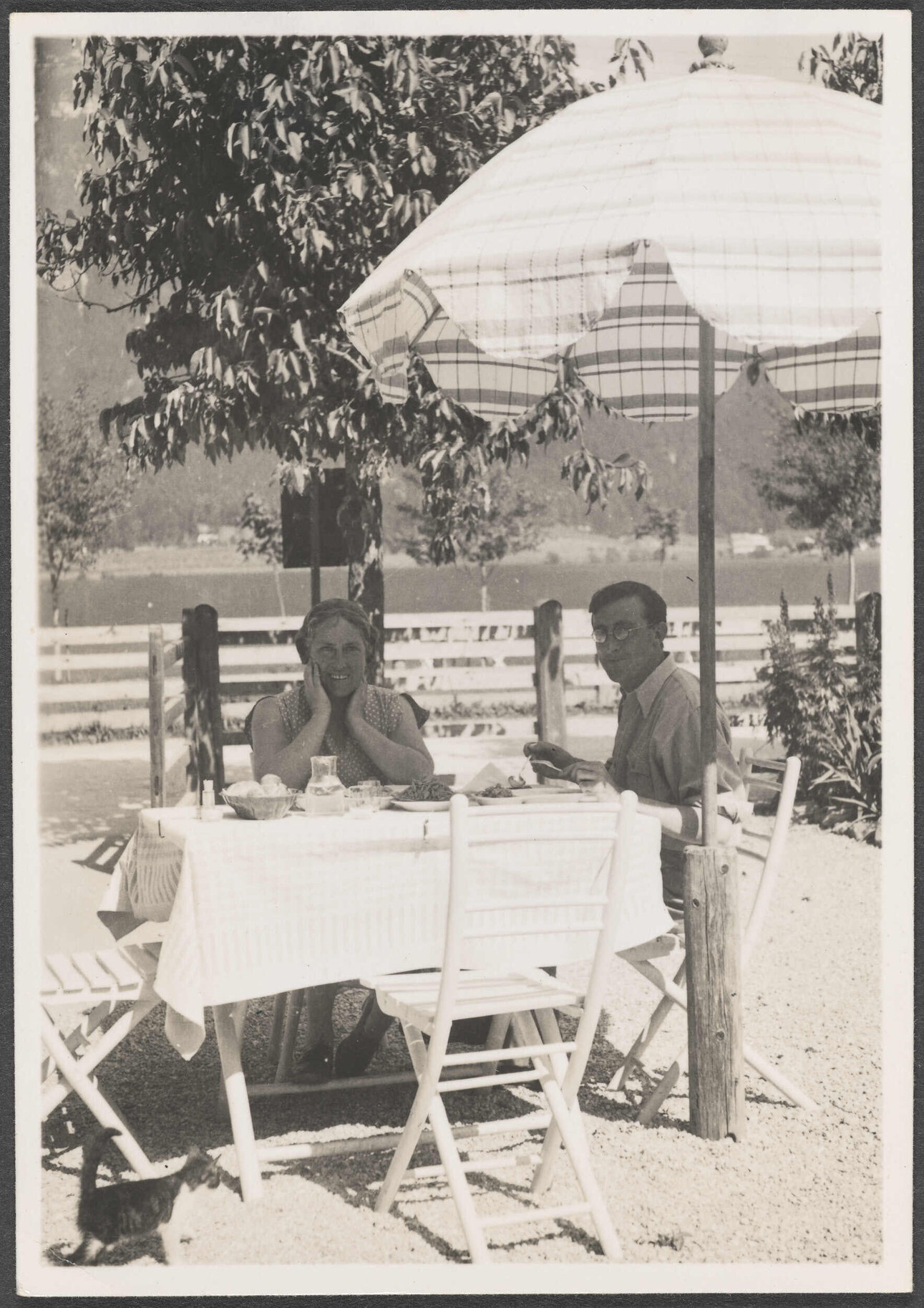 Two people eating at an outside table | Hocken Digital Collections